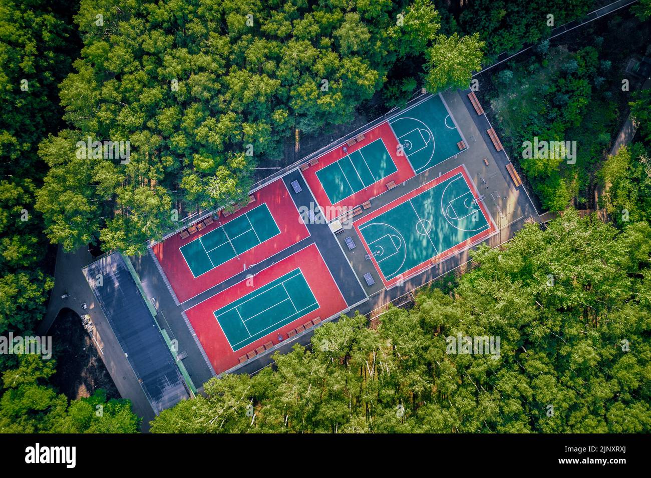 Drone top down view of beautiful sport fields in green summer city park ...