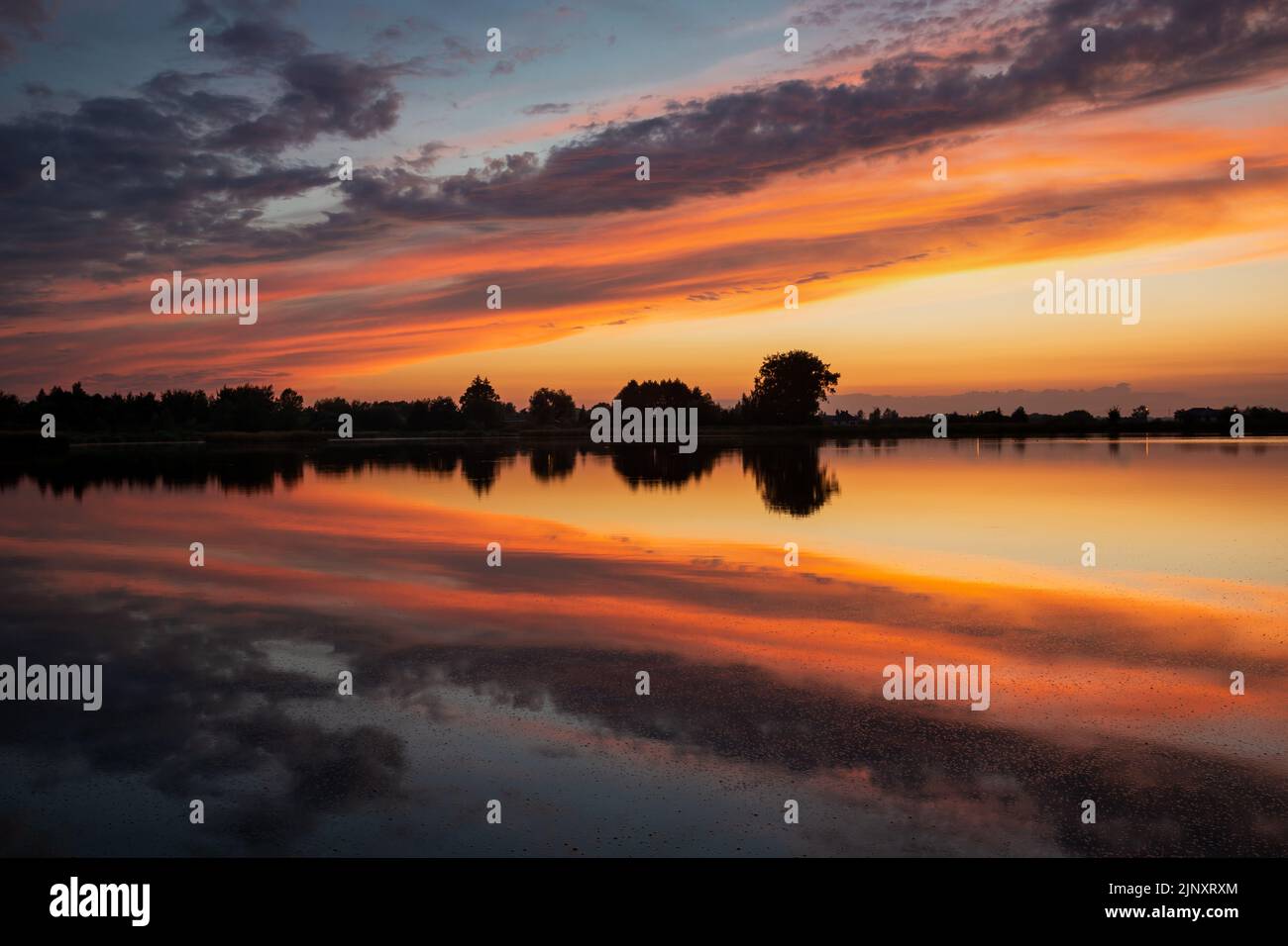 After sunset orange sky reflected in water hi-res stock photography and ...