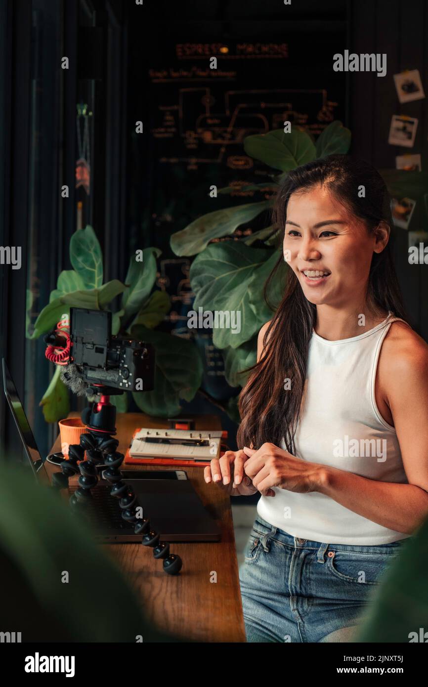 Young asian woman recording video with a camera for vlog and social ...