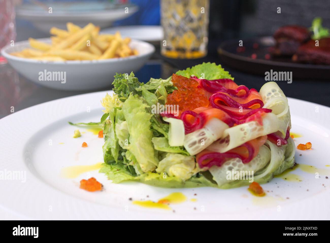 Red caviar and marinated salmon in a salad. Delicious healthy salad ...