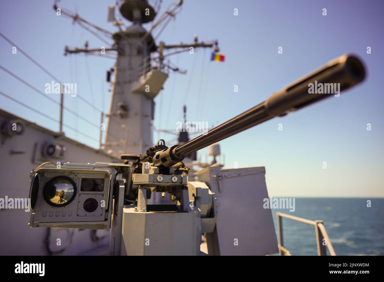 Color image of an automated machine gun on the deck of a military ship ...