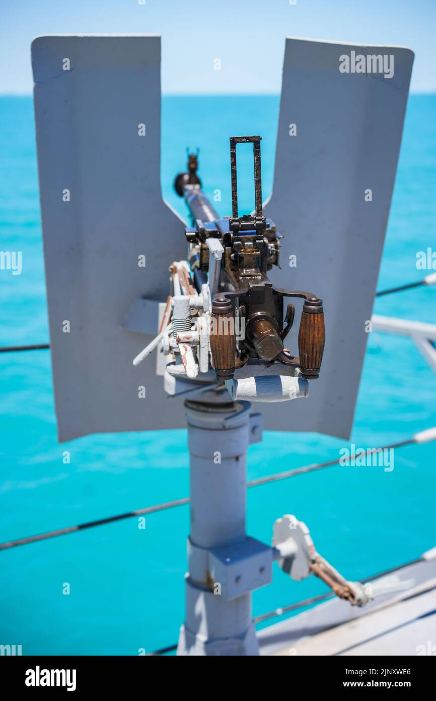 Color image of an automated machine gun on the deck of a military ship ...