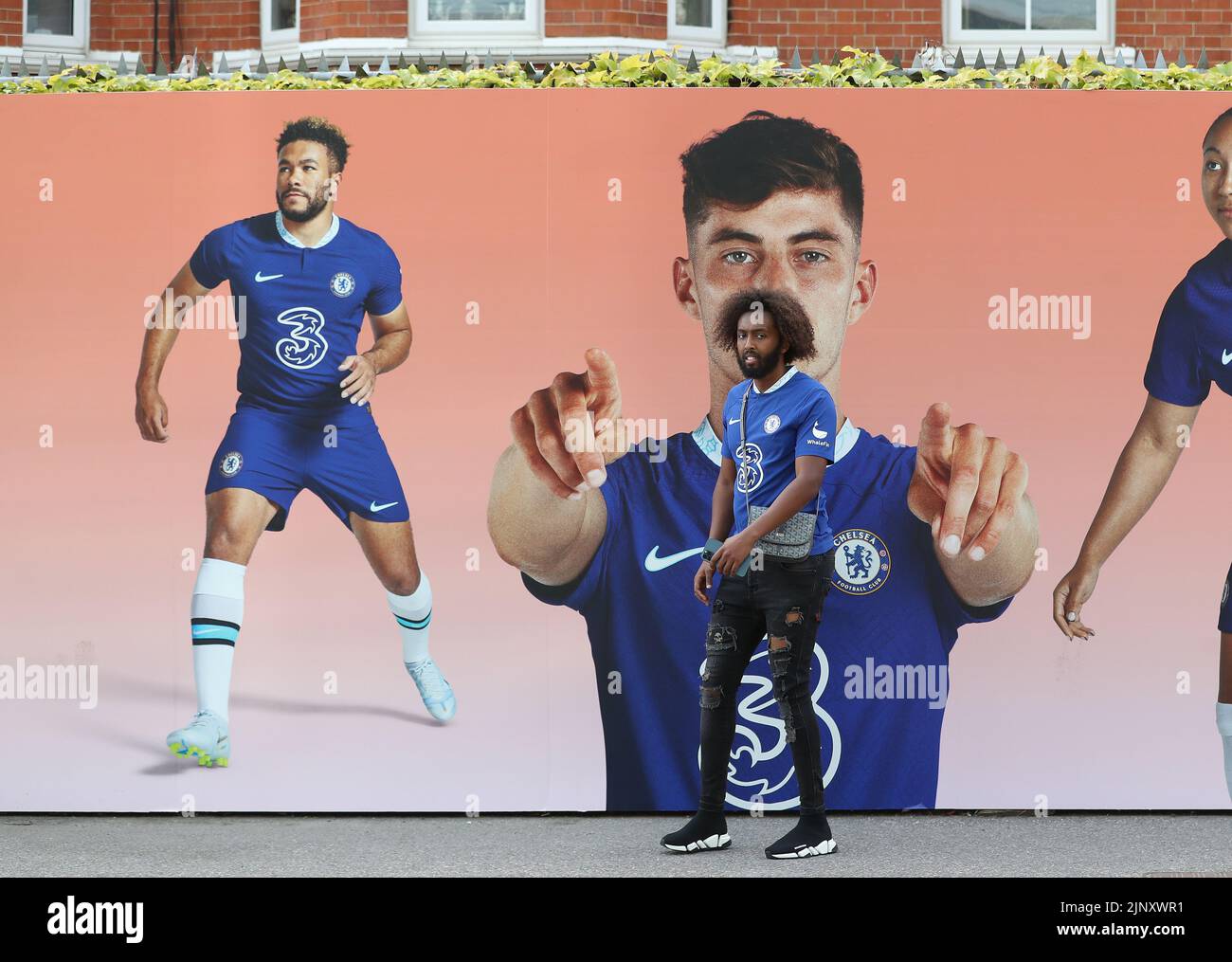 London, UK. 14th Aug, 2022. A Chelsea Fan walks past a photo of Kai ...