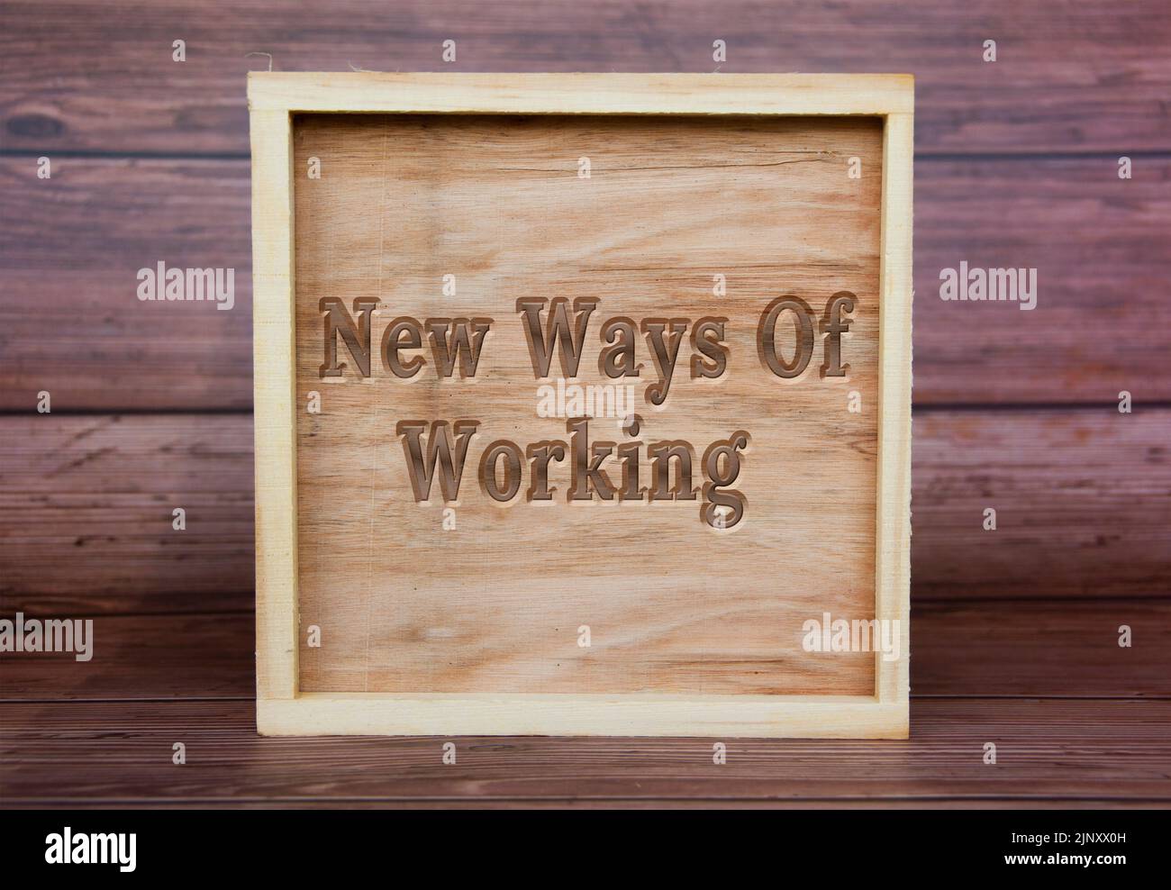 New Ways Of Working text engraved on wooden frame. New business culture ...