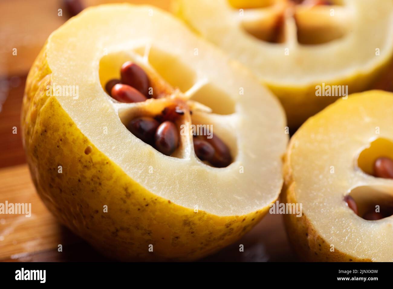 Close-up of Japanese quince. Cross-sectioned fruit with seeds in a seed ...