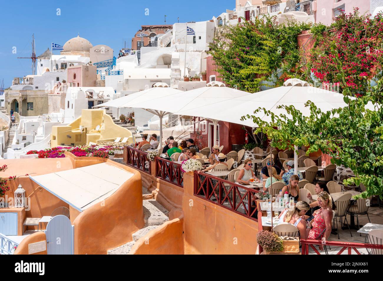 People Eating At A Restaurant Overlooking The Aegean Sea In The Town Of ...