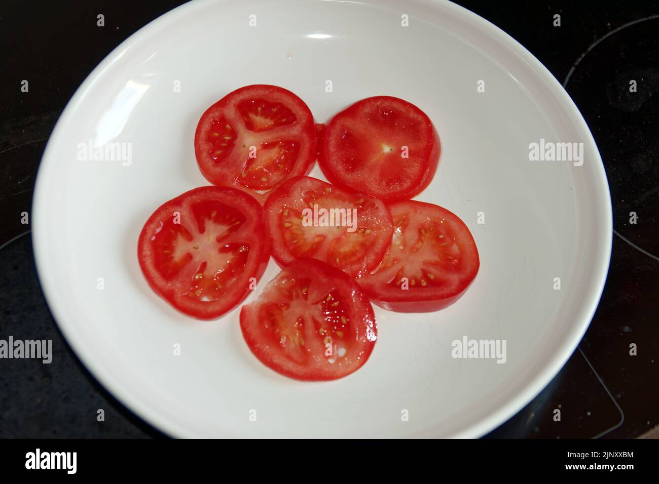 Red sweet sliced tomatoes hi-res stock photography and images - Alamy