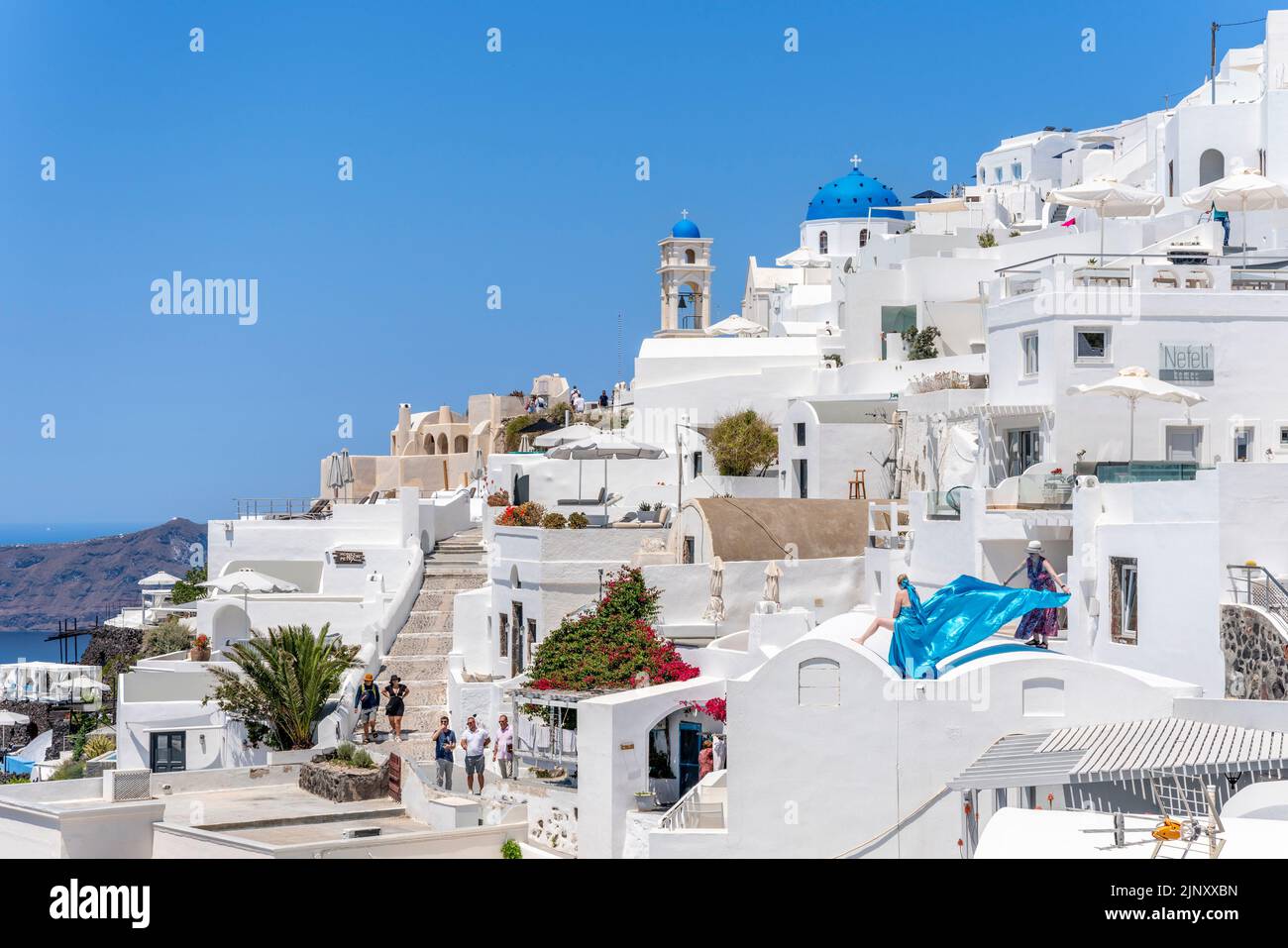 A Young Woman Poses For A Photo On The Island Of Santorini, Greek ...