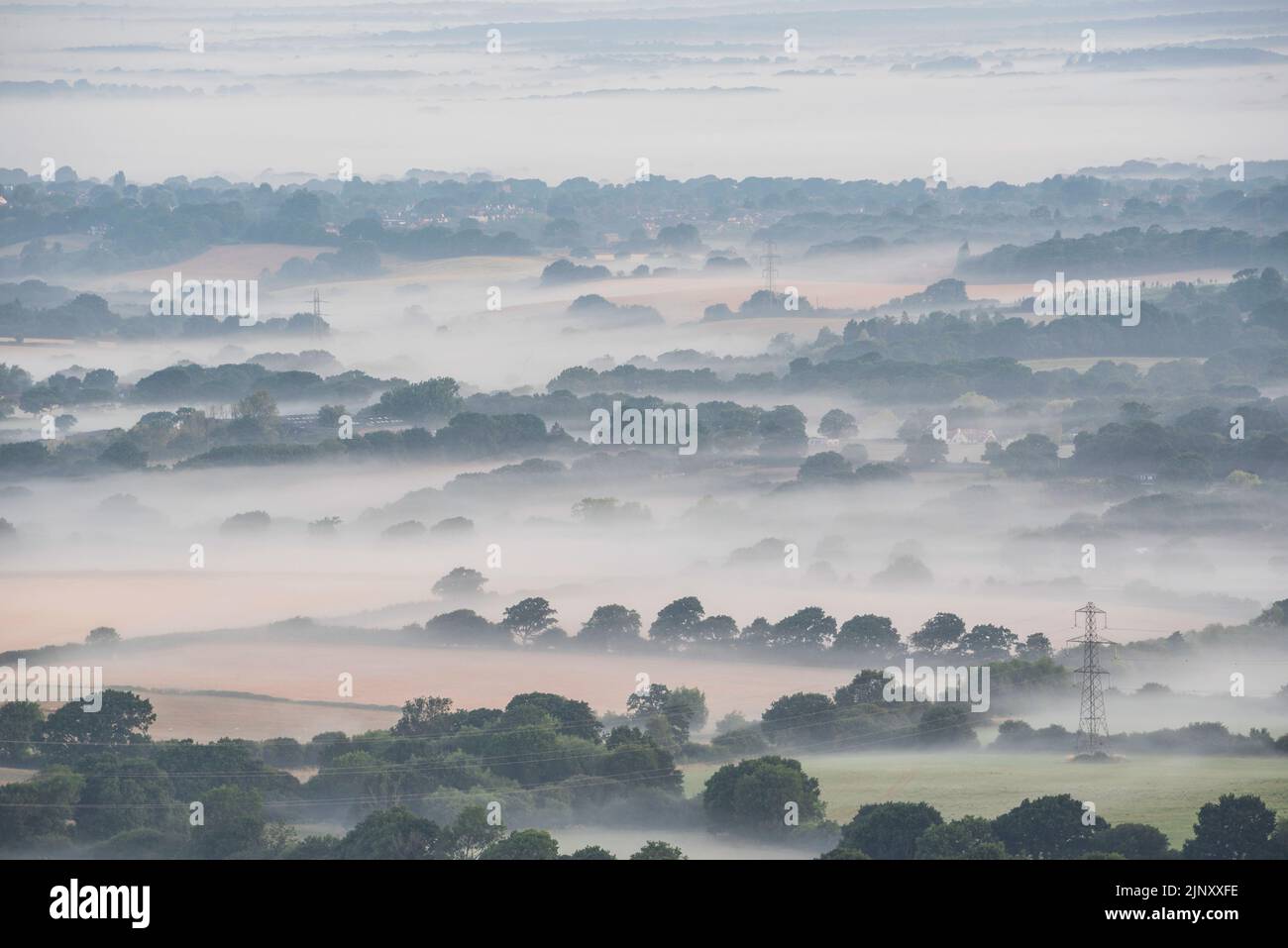 Stunning landscape image of layers of mist rolling over South Downs ...