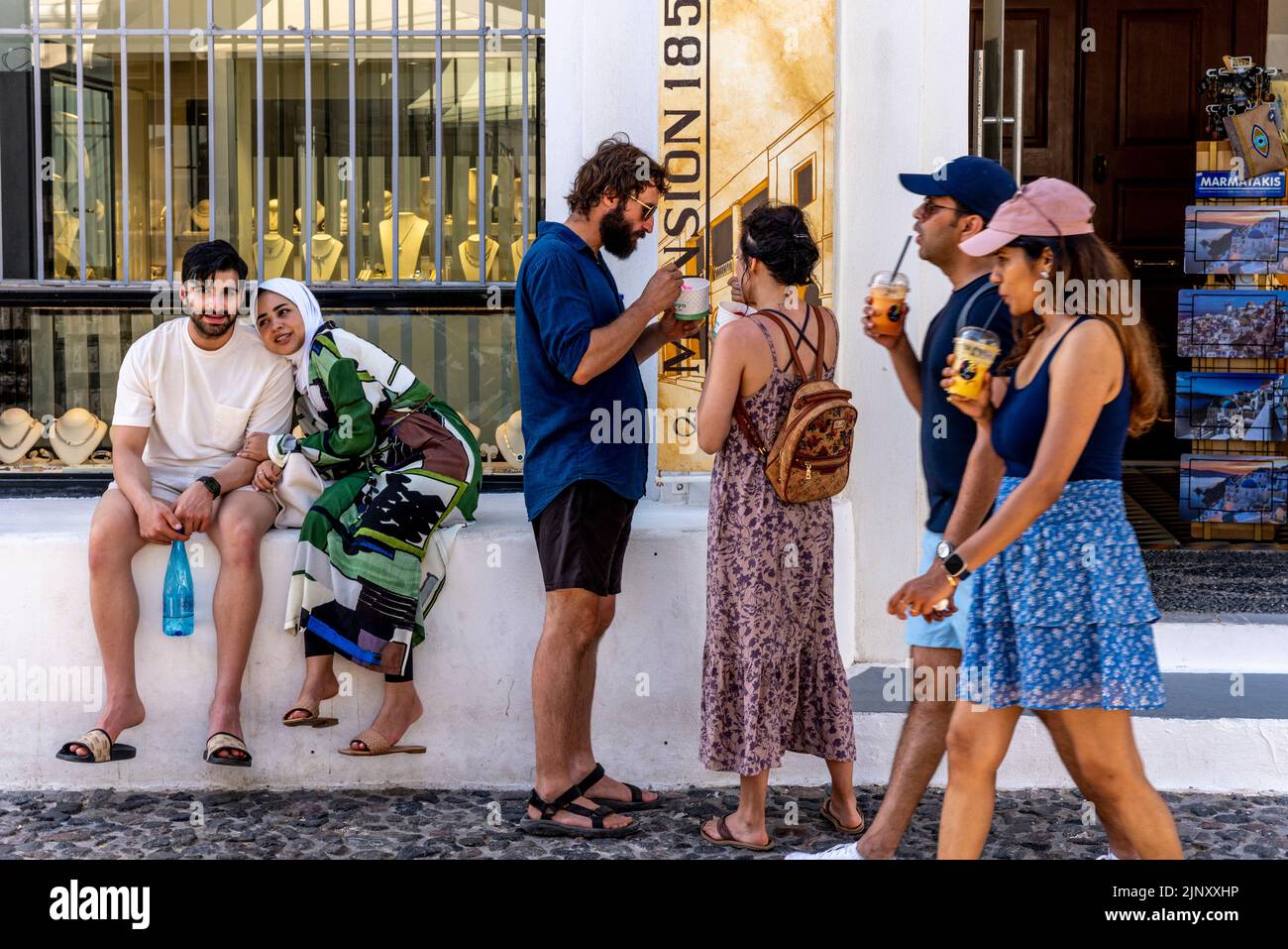 A Group Of Young Visitors In The Town Of Thira, Santorini, Greek ...