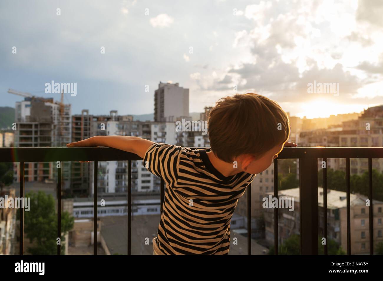 Unsupervised toddler climbing dangerous balcony railing Risky child ...