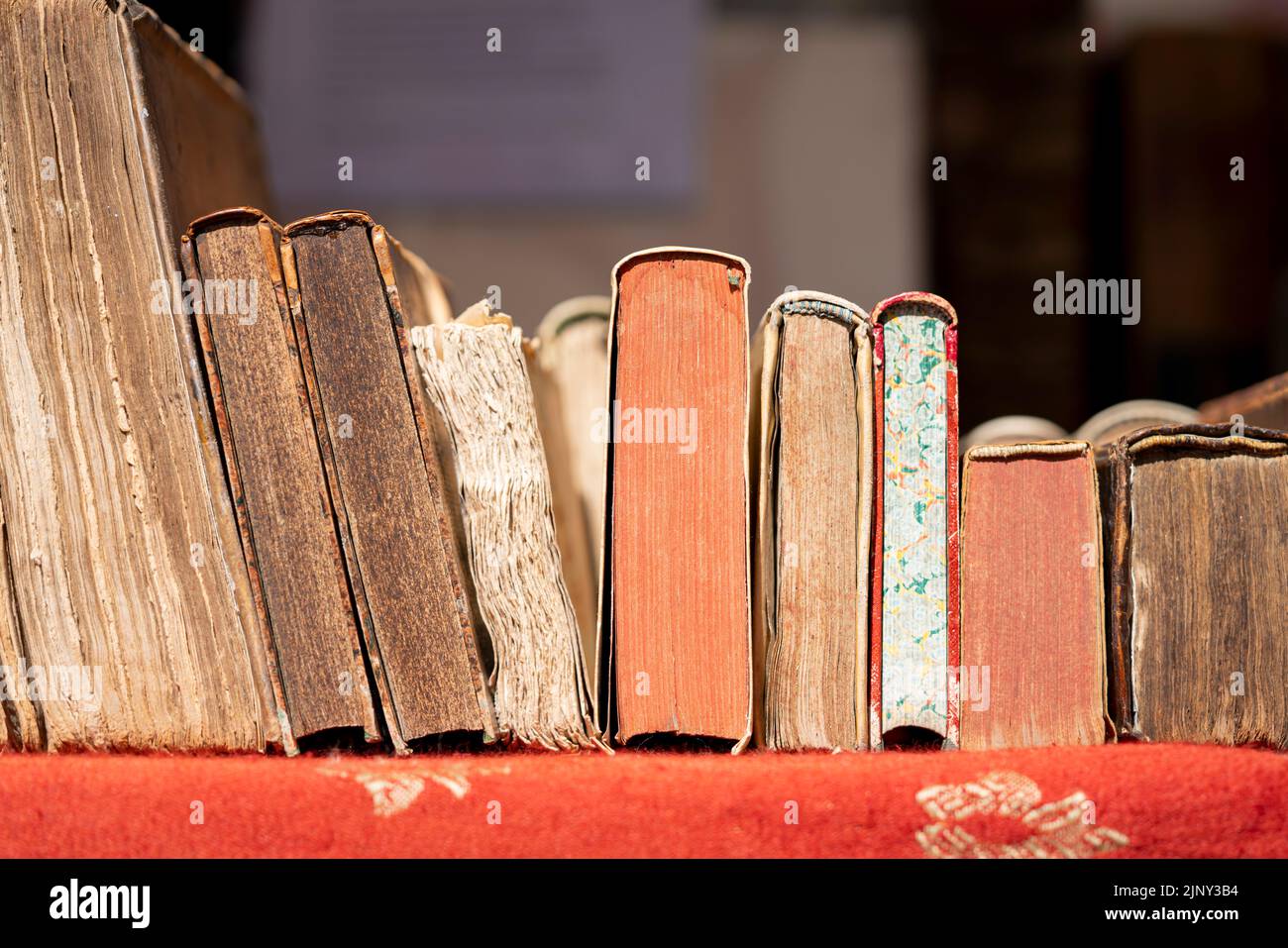 Old books resting on a market stall table being sold at an antique book ...