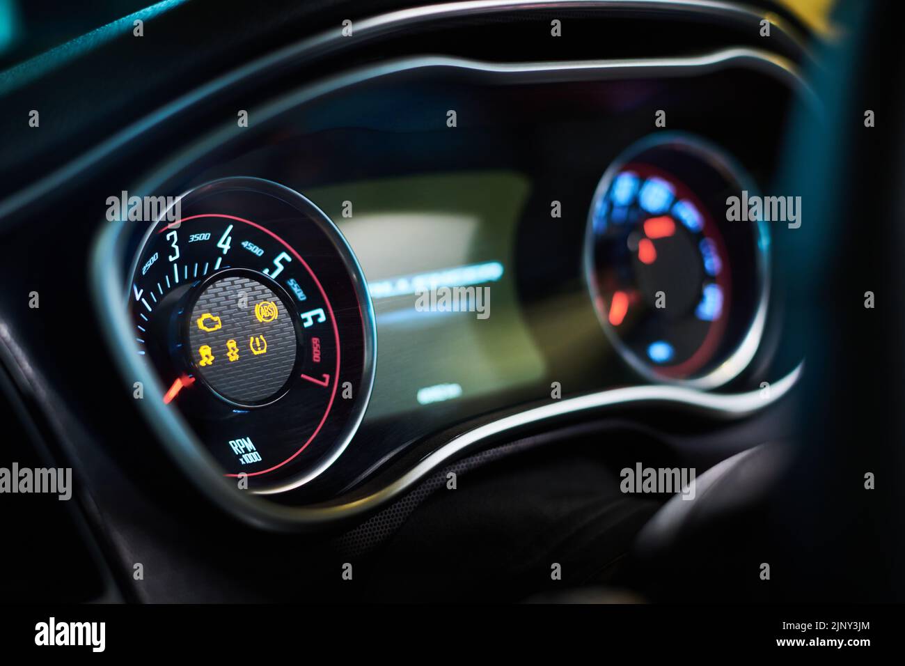 Part of car interior with instrument panel containing two speedometers ...