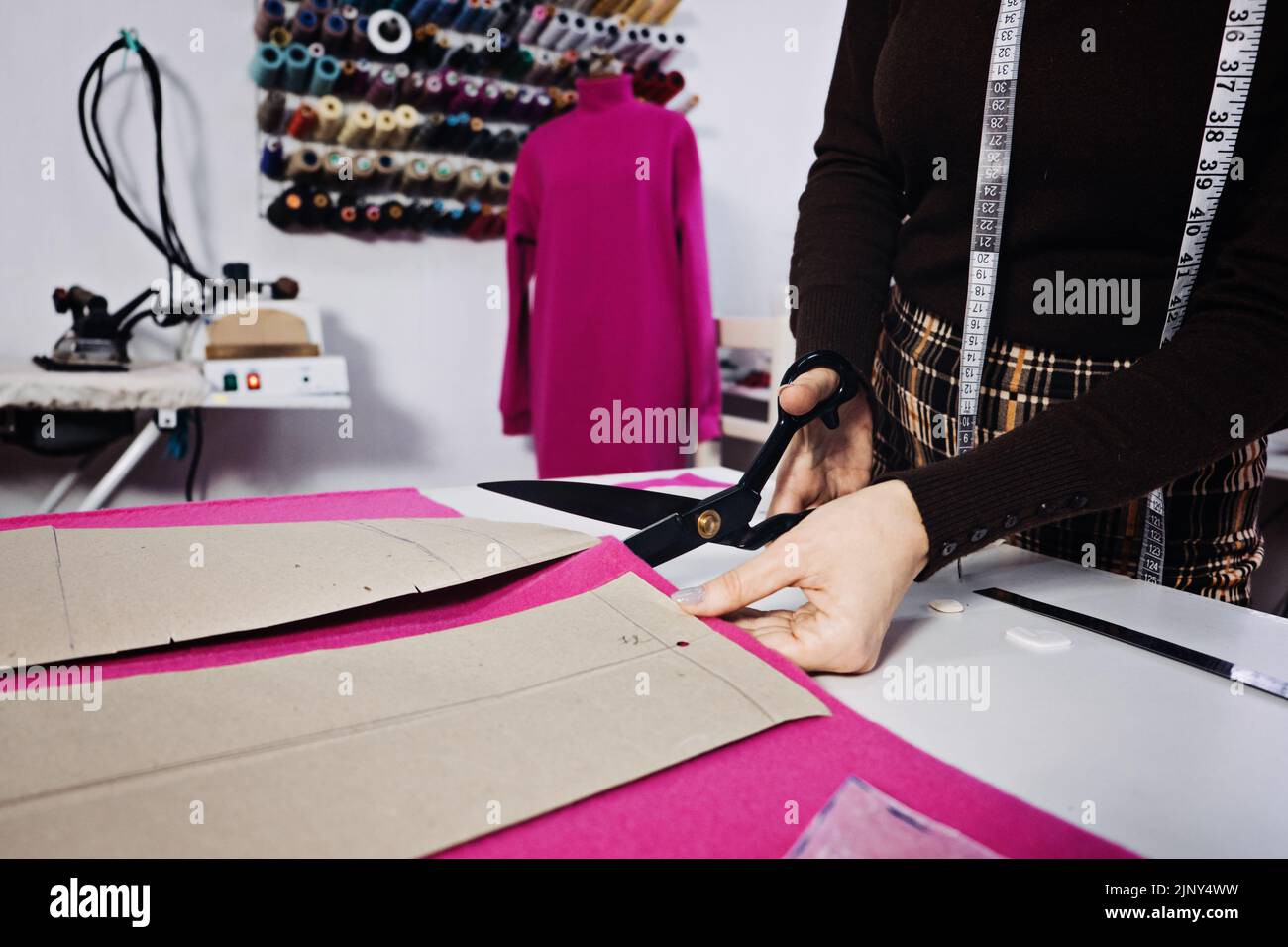 Hand Cutting Pattern and Fabric Pieces. Fashion Design. Female tailor ...