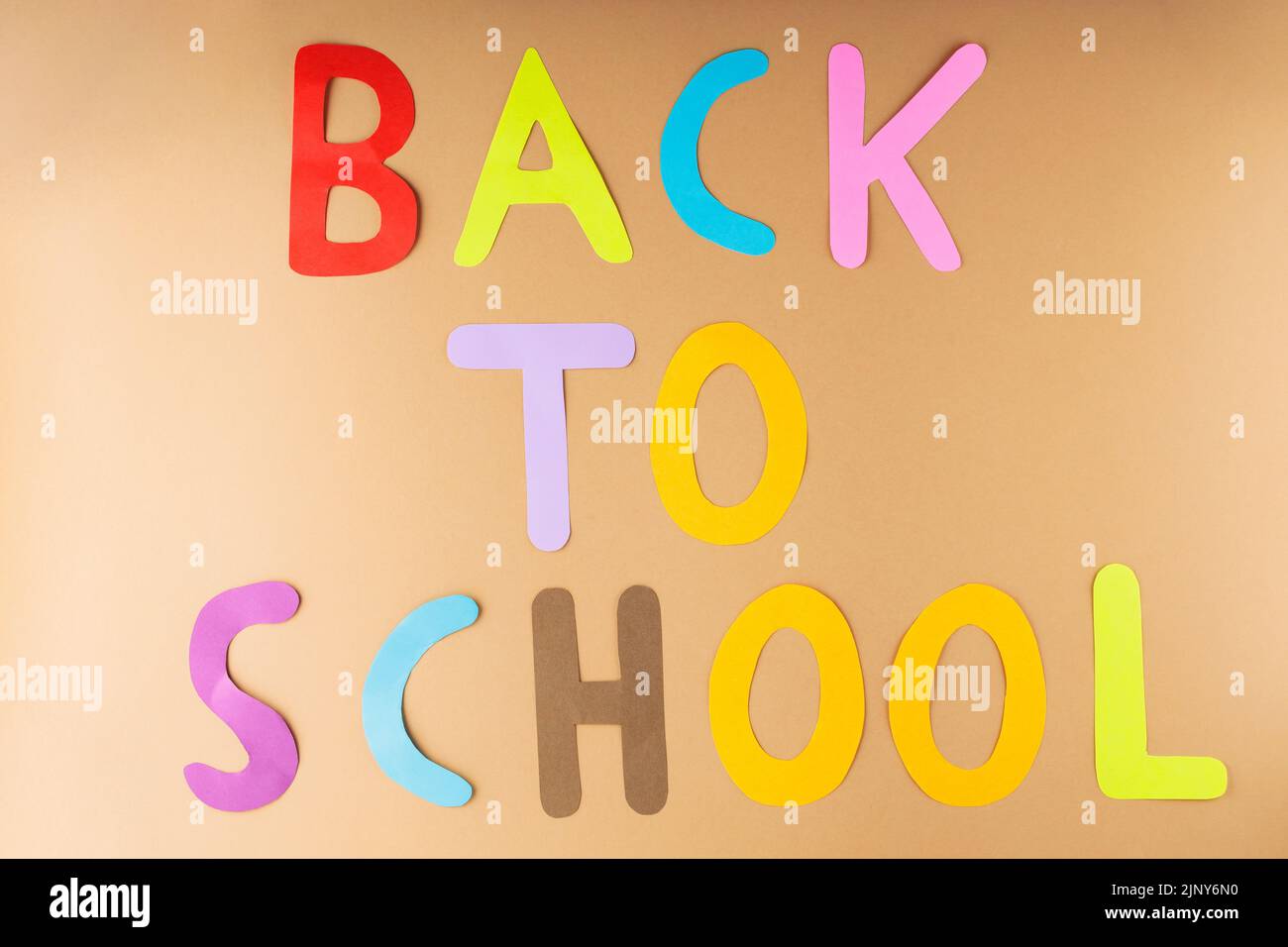 Back to school on a beige background. Inscription Back to school with ...