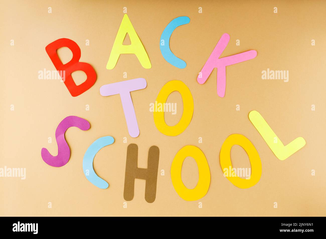 Back to school on a beige background. Inscription Back to school with ...
