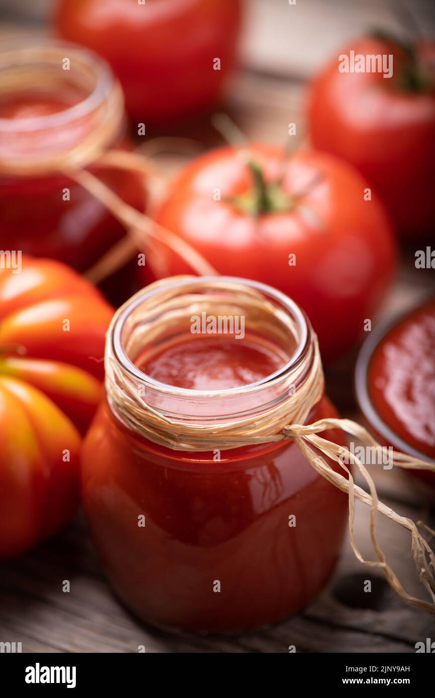 A traditional homemade tomato sauce and tomatoes close up Stock Photo ...