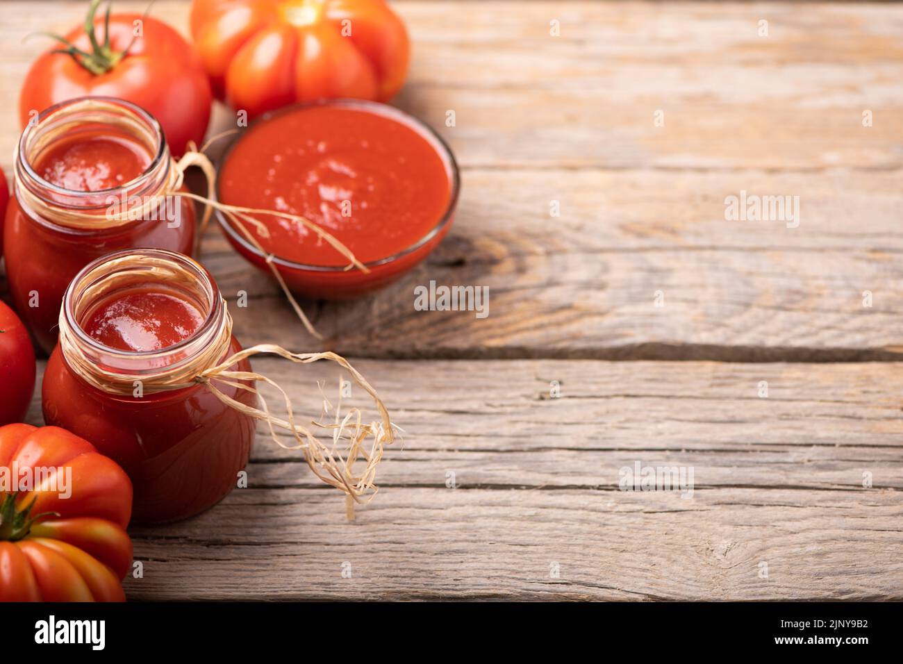 A traditional homemade tomato sauce and tomatoes close up Stock Photo ...