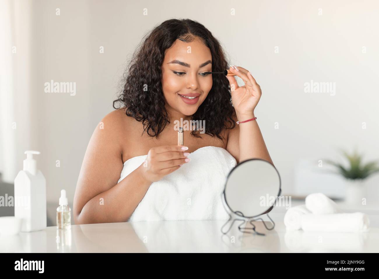 Overweight woman looking in mirror hi-res stock photography and images ...