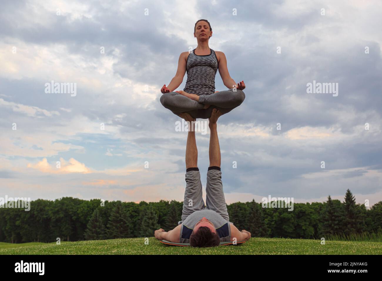 Strong acrobatic woman lifting man hi-res stock photography and images ...