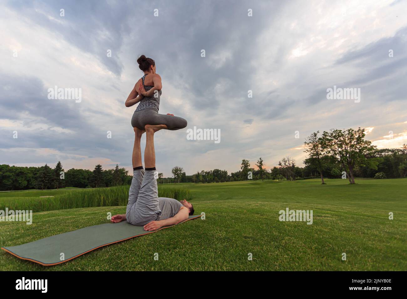 Strong acrobatic woman lifting man hi-res stock photography and images ...