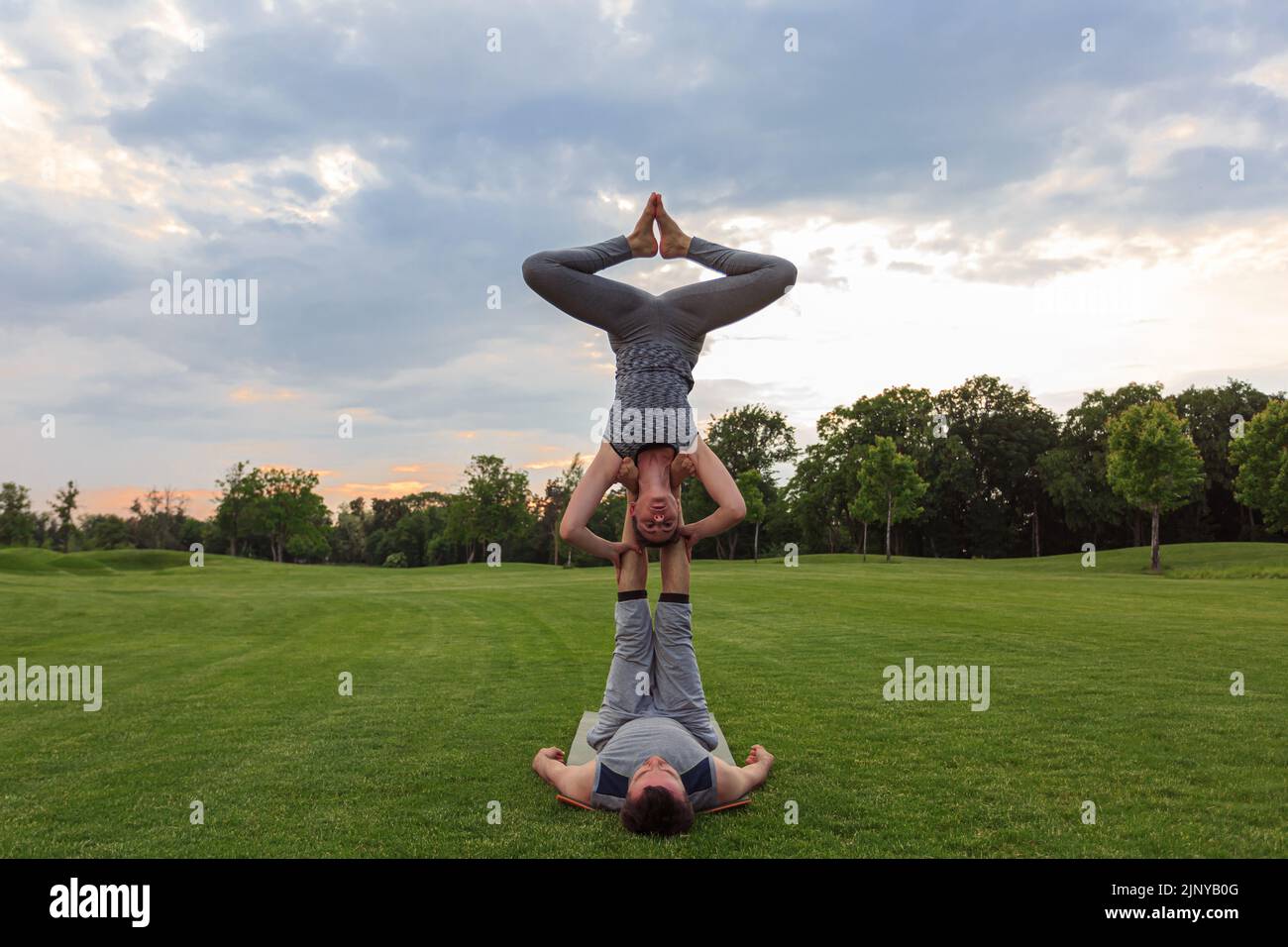 Strong acrobatic woman lifting man hi-res stock photography and images ...