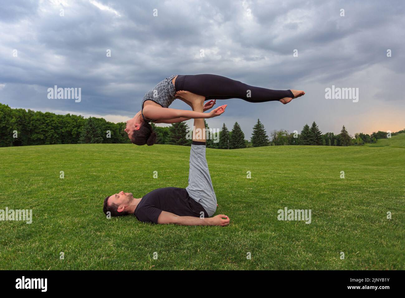 Strong acrobatic woman lifting man hi-res stock photography and images ...