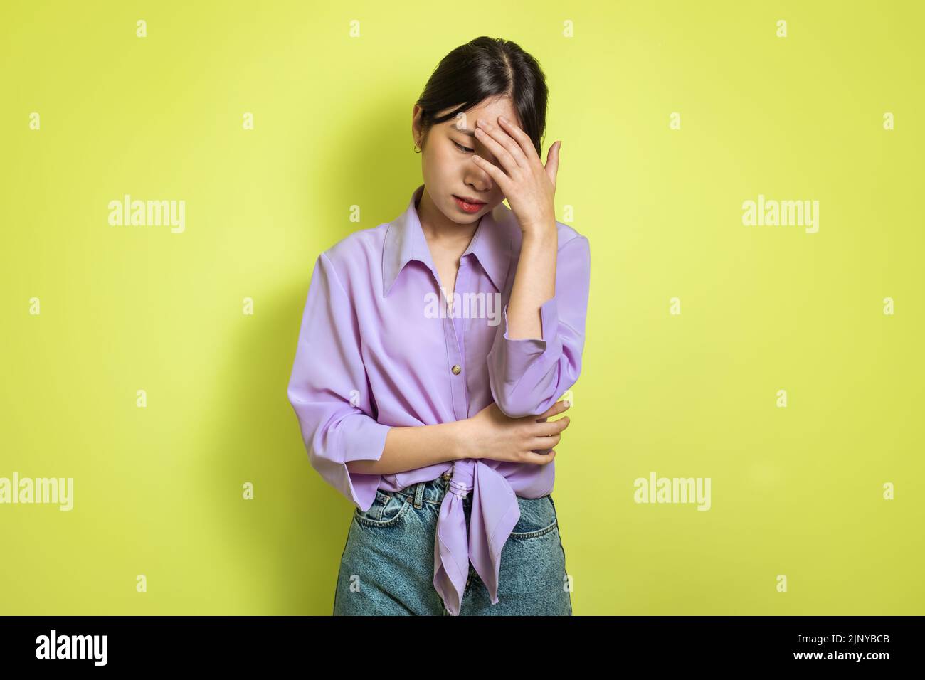 Unhappy Asian Lady Covering Face Crying Over Yellow Studio Background ...