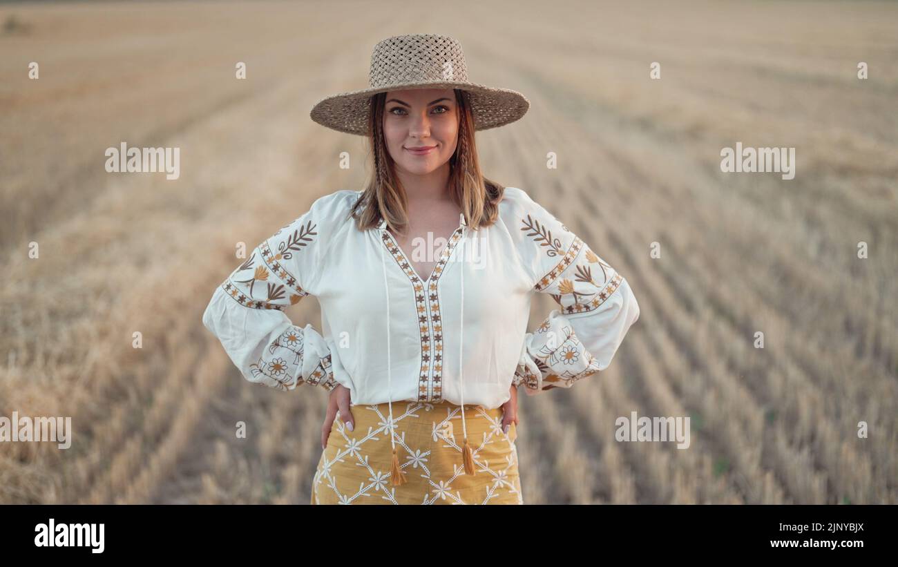 Portrait of ukrainian woman in wheat field after harvesting. Attractive ...