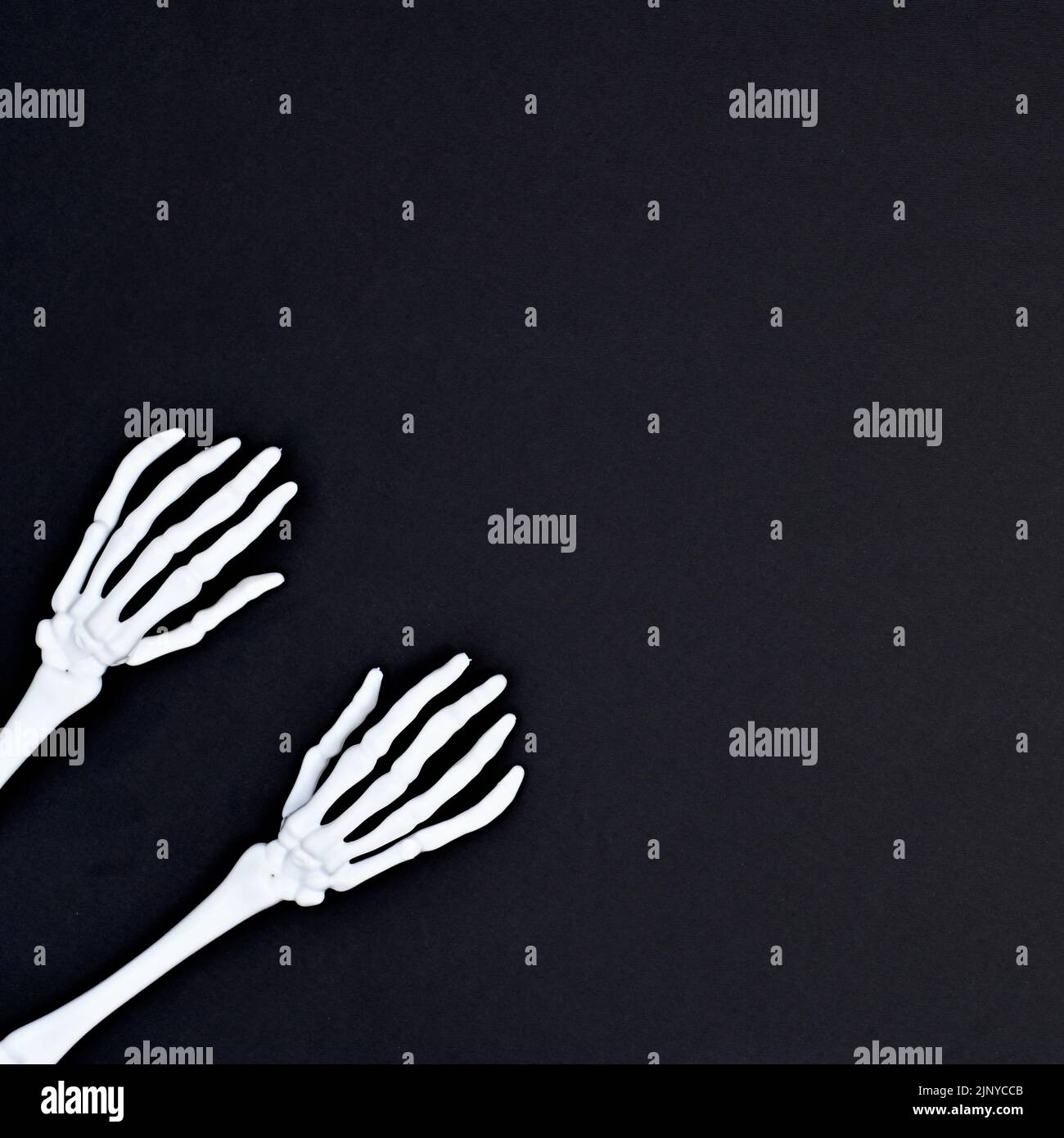 Scary skeleton hands on dark black background for Halloween with copy ...