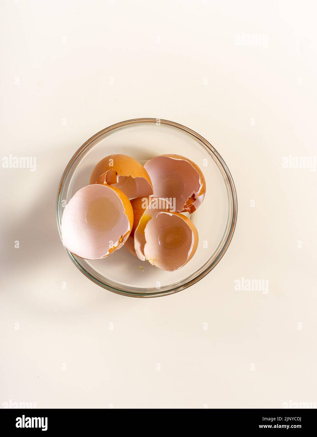 Eggs shell in glass bowl isolated on a white background. Flat lay. Top ...