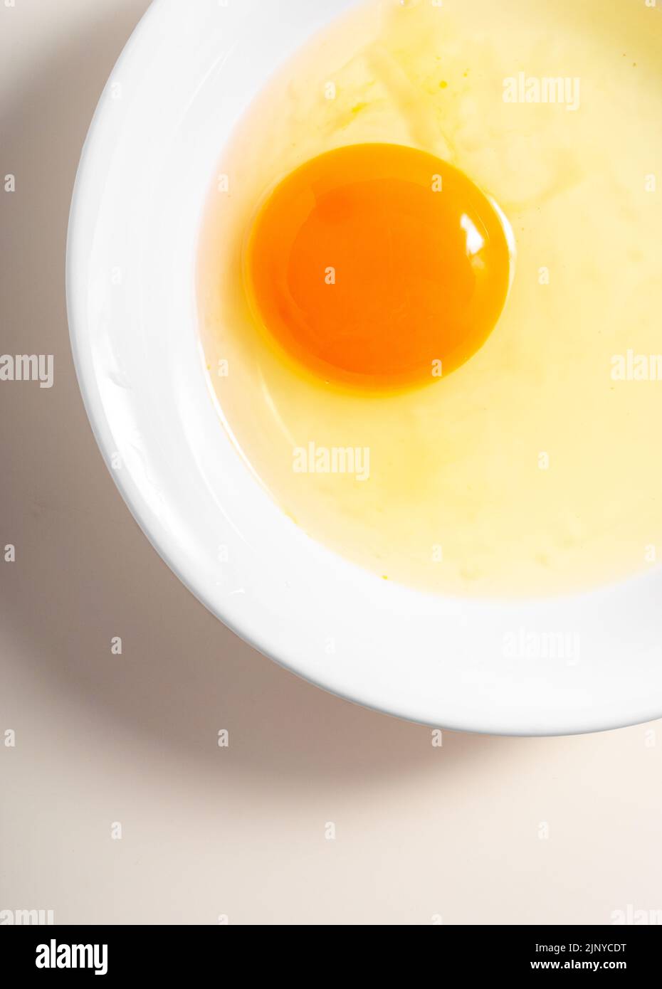 Raw eggs. Close up. flat lay raw eggs yolk in bowl. Isolated broken ...