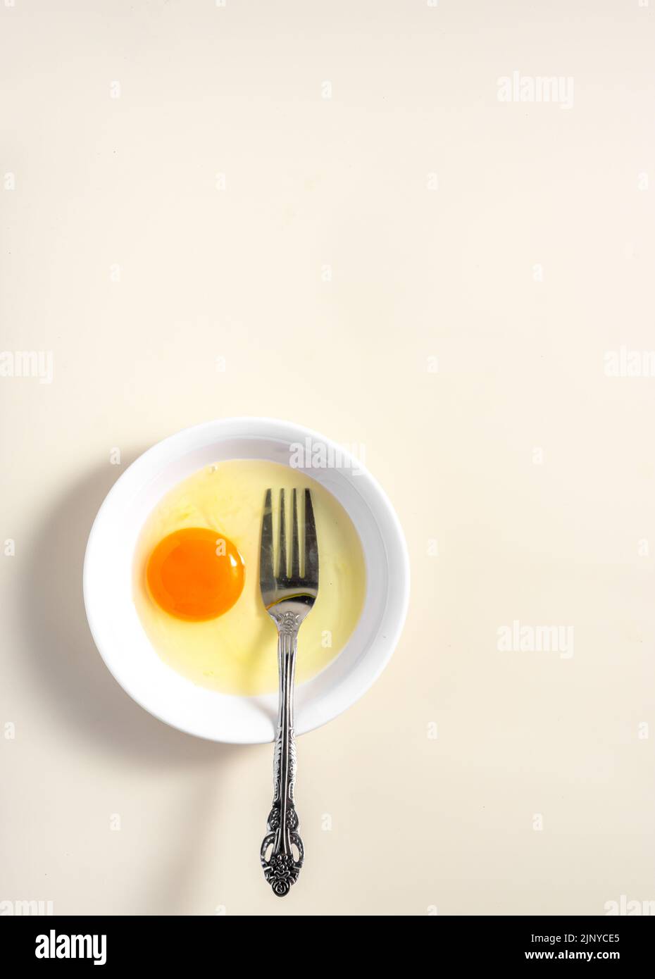 Raw eggs. Close up. flat lay raw eggs yolk in bowl. Isolated broken ...