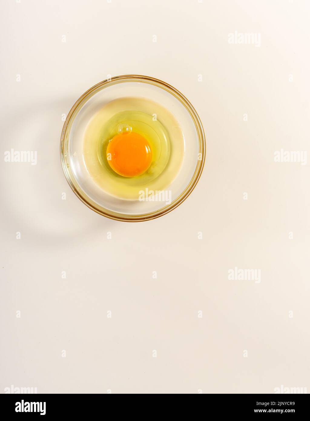 Raw eggs. Close up. flat lay raw eggs yolk in bowl. Isolated broken ...