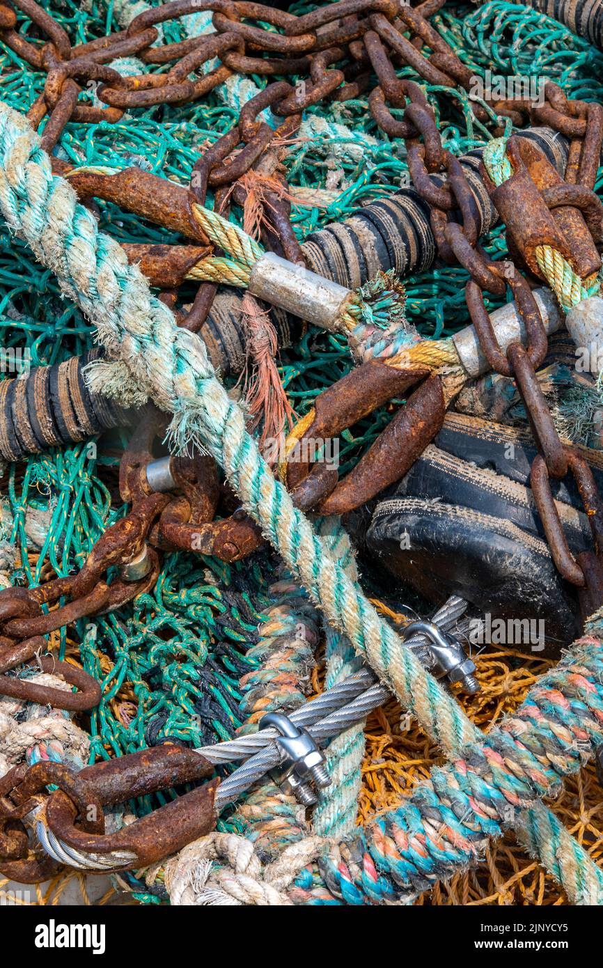 tangle of disused ropes and wires on a quayside in greece, discarded ...