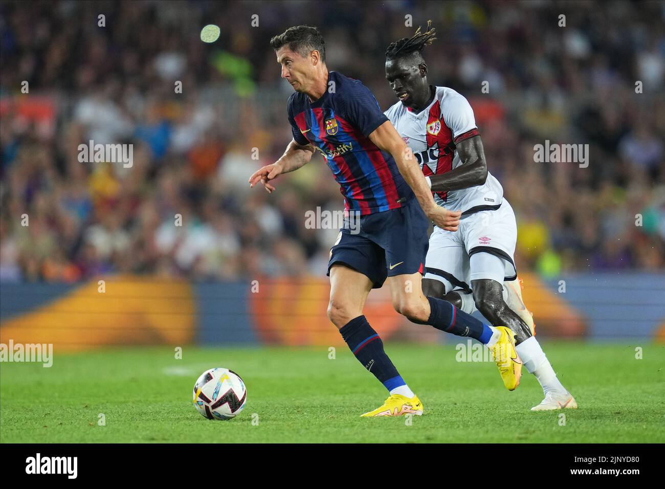 Robert Lewandowski of FC Barcelona and Pathe Ciss of Rayo Vallecano ...
