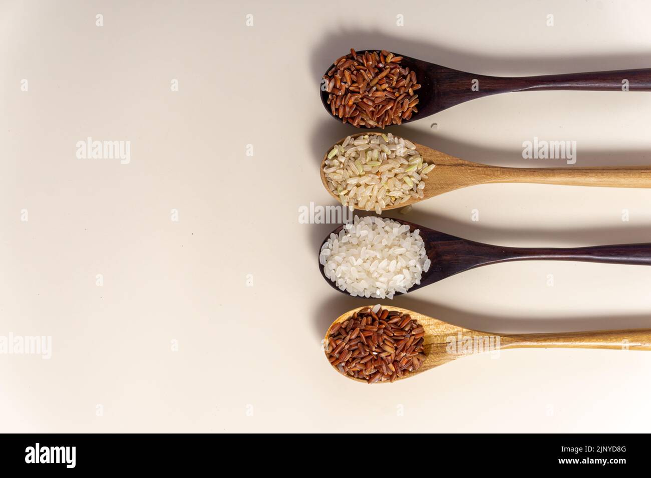 Raw rice assortment in bowl on white background. Horizontal. Place for ...