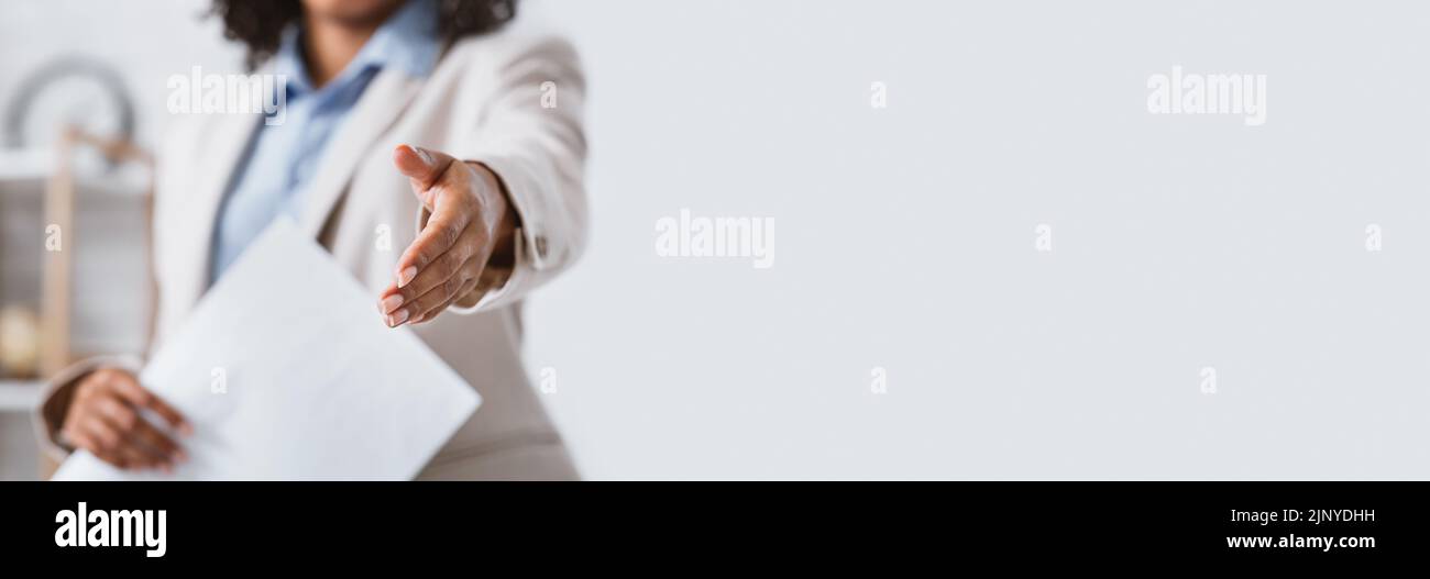 Unrecognizable Black Businesswoman Holding Papers And Giving Hand For ...
