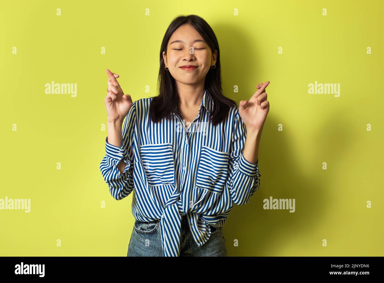 Woman crossing arms fingers hi-res stock photography and images - Alamy