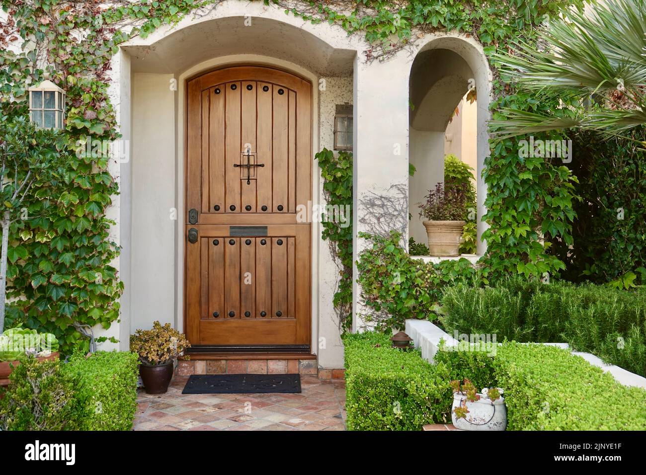 Italian villa style front door with ivy covered walls Stock Photo - Alamy