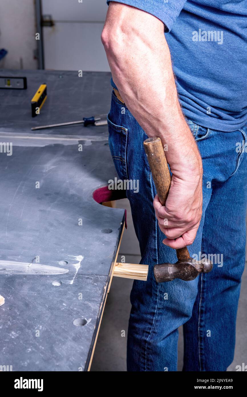 Wood shims used to help level the slate of a pool table Stock Photo - Alamy