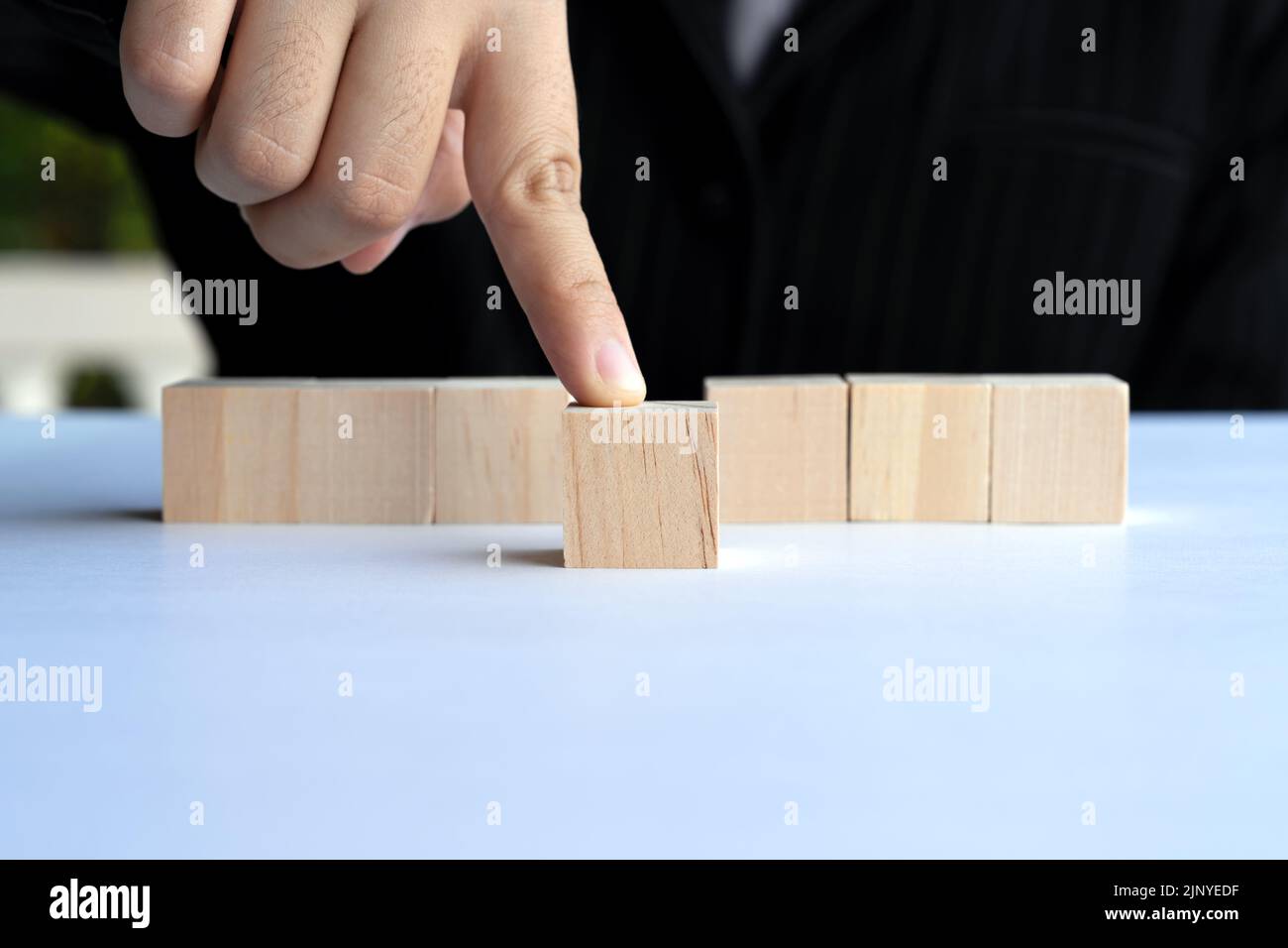 Hand pushing out one wood block, blank template Stock Photo - Alamy