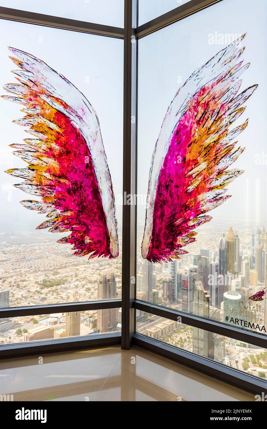 Dubai, UAE - 07.18.2021 - Wings application on the glass at the highest ...
