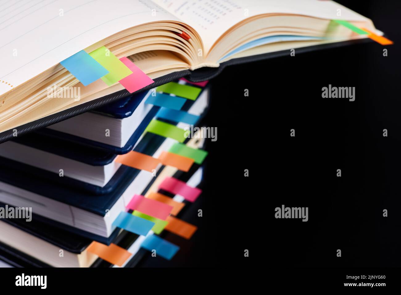 Close-up of a stack of office notepads with colorful sticky page ...