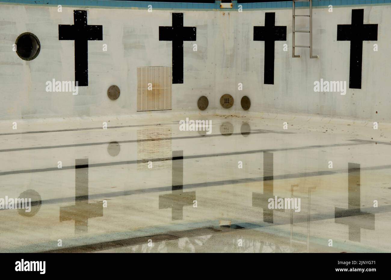 Empty swimming pool crosses with reflections Stock Photo - Alamy