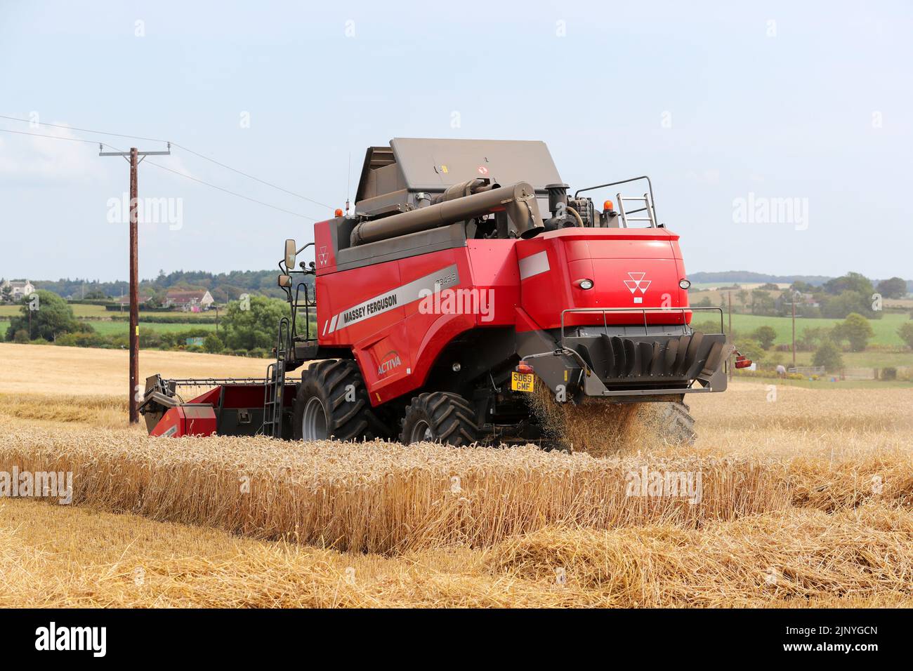 Farmer using a Massey Ferguson Activa 7345S combine harvester, with a ...