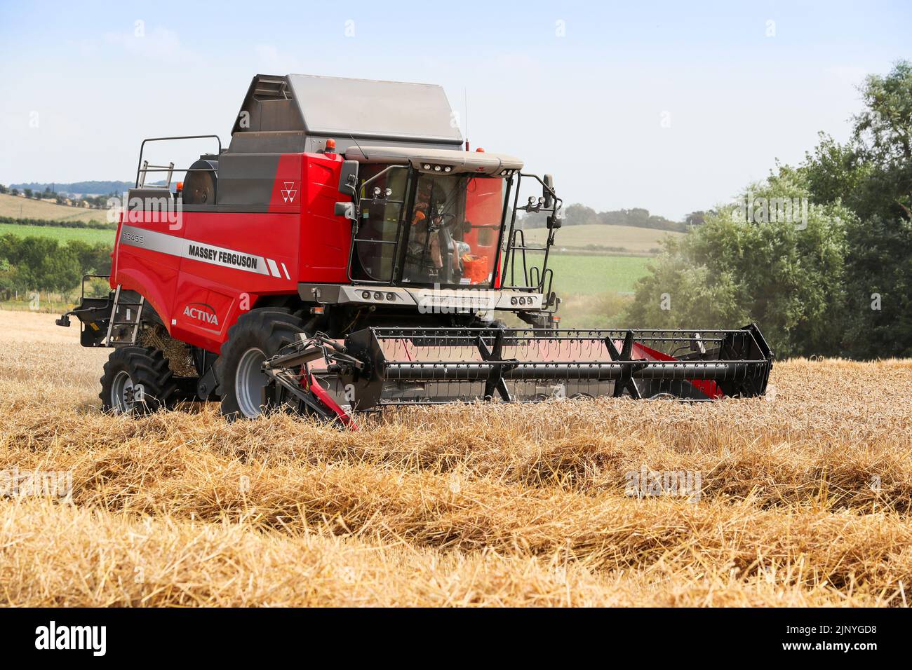 Farmer using a Massey Ferguson Activa 7345S combine harvester, with a ...