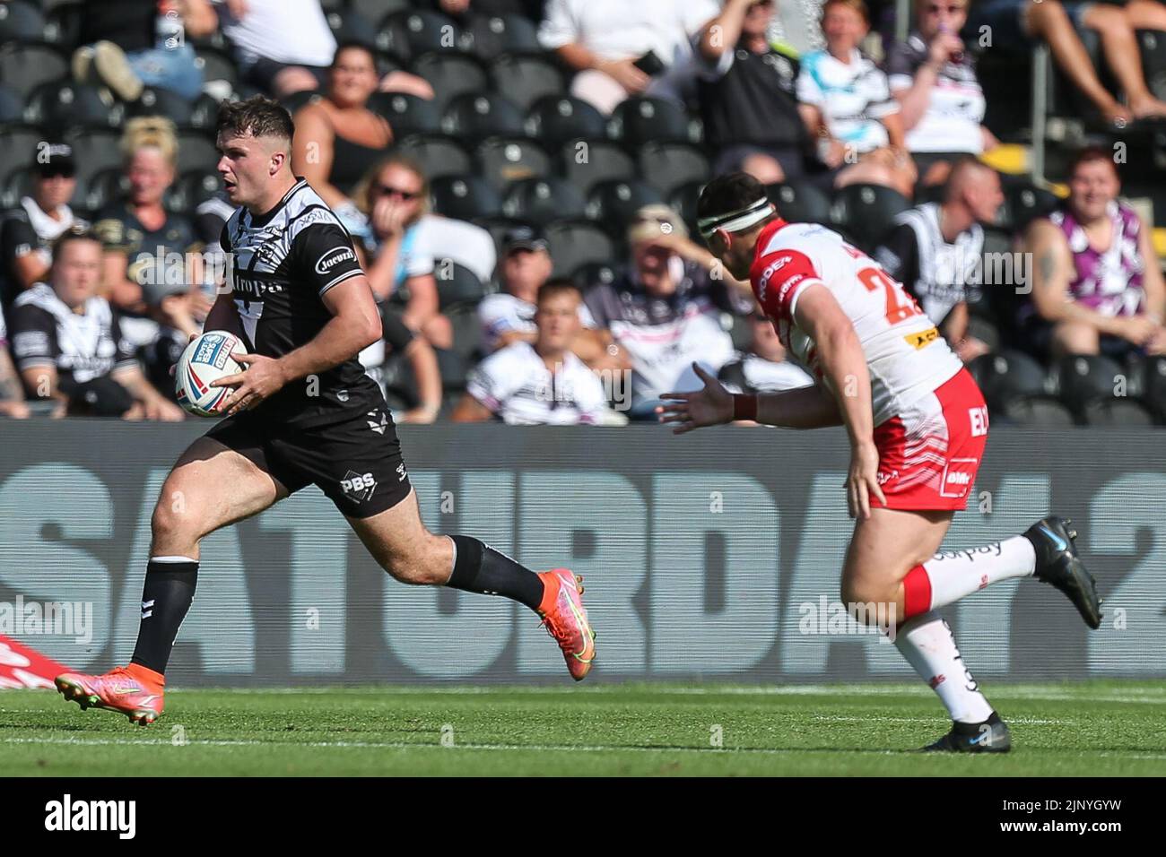 Connor Wynne #23 of Hull FC gets away from Ben Davies #22 of St Helens ...