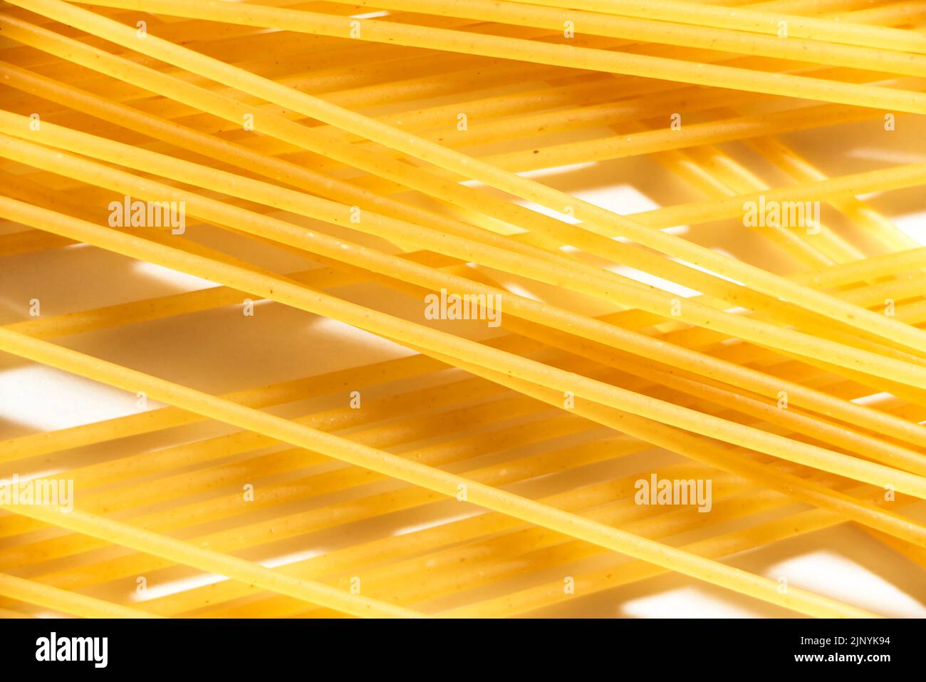 Italian food background, raw spaghetti in a textured design of uncooked ...