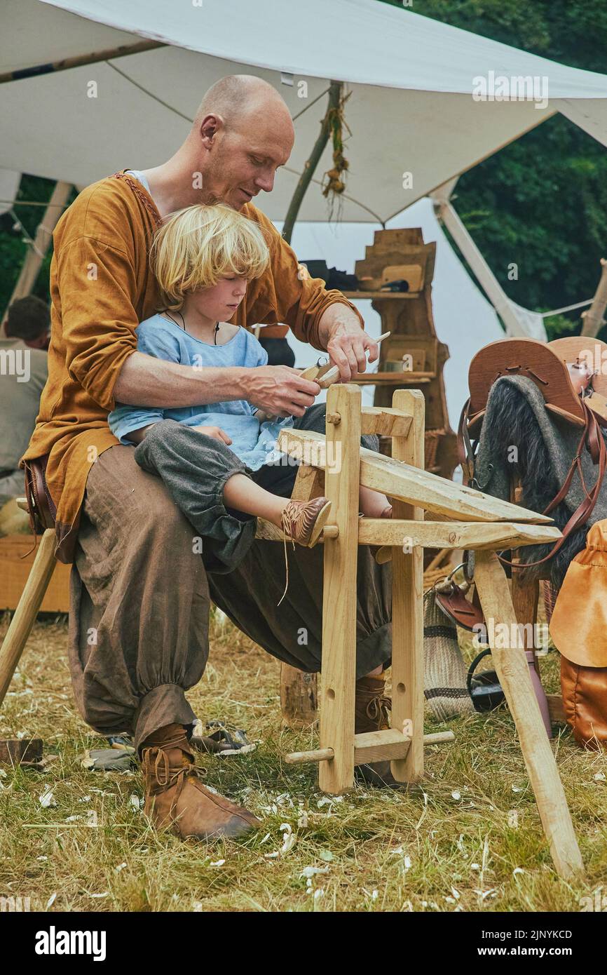 Hojbjerg, Denmark, August, 2022: Father carpenter teaching his son ...